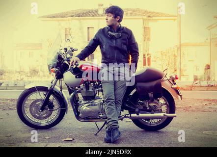 young biker relaxing leaning your motorcycle Stock Photo - Alamy