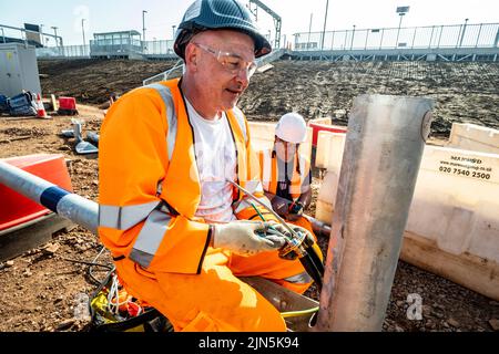 Railway workers building new railway and knocking down bridges Stock ...