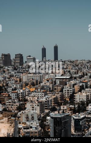 A vertical aerial view of the buildings of Amman during a cloudy day in ...
