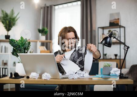 Irritated man in glasses, dressed in a white T-shirt, a man ...