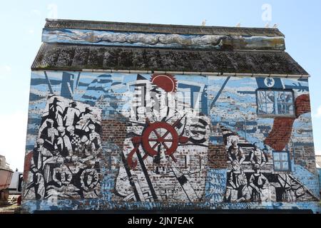 Mural of fisherman on side of building in Mallaig Harbour ...