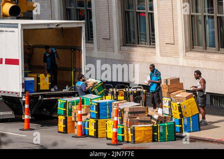 Workers sort Amazon deliveries for distribution in the Greenwich ...