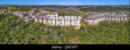 Austin, Texas- Mountain top with apartment complex buildings against ...