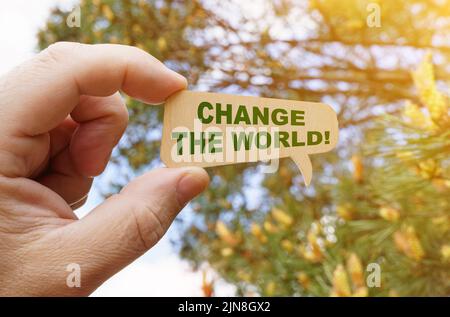 Ecology concept. A man holds a sign inside which the inscription ...