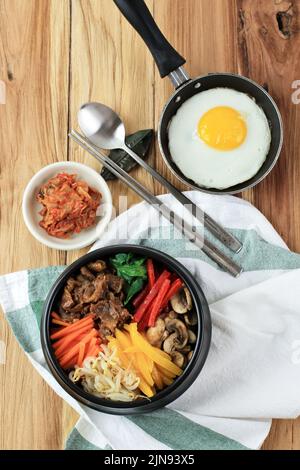 Bowl of bibimbap on the wooden table Stock Photo - Alamy