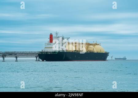LNG tanker during loading at an liquefied natural gas offshore terminal ...