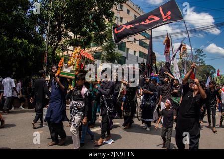 Bangladeshi Shia Muslims march and carry the flags and Tazia during a ...