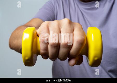 yellow gymnastic weights in hand on a transparent background Stock ...