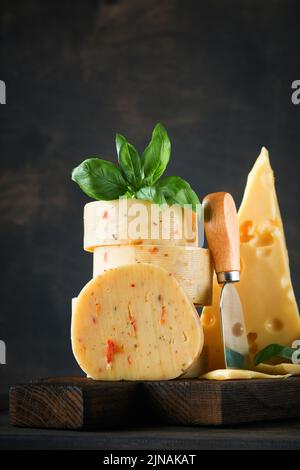 Stack of cheese with tomatoes and seasoning and Swiss cheese on with ...