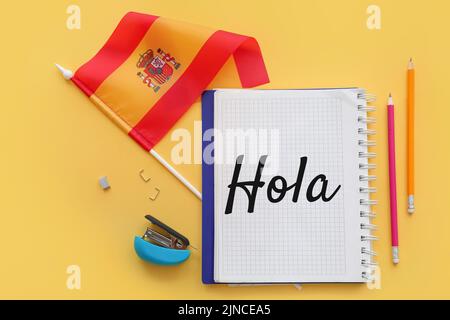 Notebook with text HOLA (Spanish for HELLO), flag of Spain and ...
