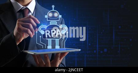 Businessman on dark background. RPA concept Stock Photo - Alamy