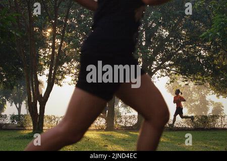 Young women badminton players are running circle a park during a ...