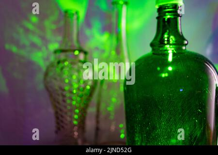 Abstract image of shaped glass bottles with a bright reflection on the ...