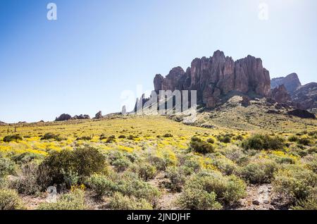 Steep rock formations and yellow flowers on the hills below in Lost ...