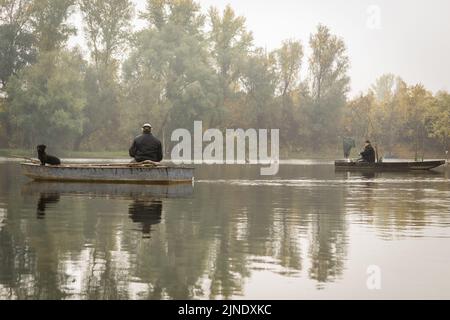 Sports fisherman in a wooden boat Stock Photo - Alamy