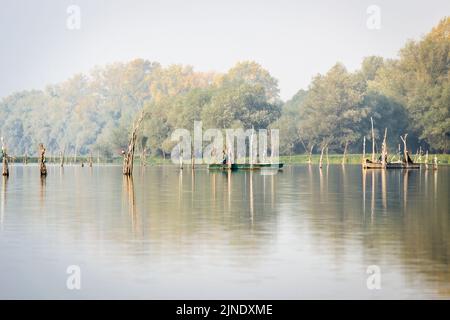 Sports fisherman in a wooden boat Stock Photo - Alamy