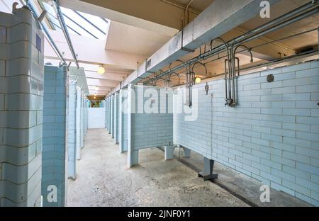 Blue tiled changing room in leisure centre by Wates Construction for ...