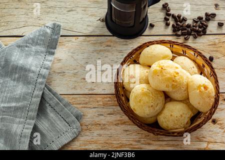 top view of brazilian cheesebread, or cheese bun with coffee beans over ...