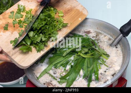 Preparing traditional Suki soup by cooking in a pot Stock Photo - Alamy