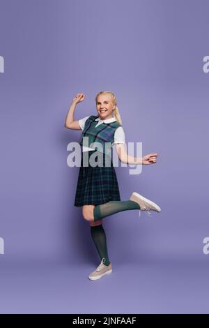 a beautiful woman is standing by a PURPLE car with flowers Stock Photo ...