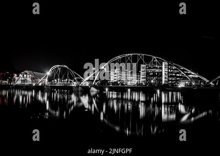 Night shot of Tempe town lake with the famous rainbow colored bridge in ...