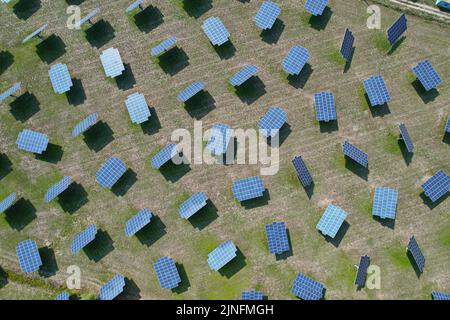 Blue rotating solar panels tilted axis tracker, future energy concept ...