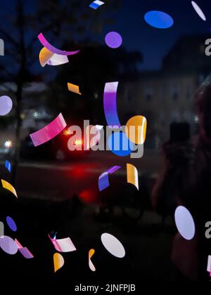 Colorful shapes and reflections from the street in an opaque store ...