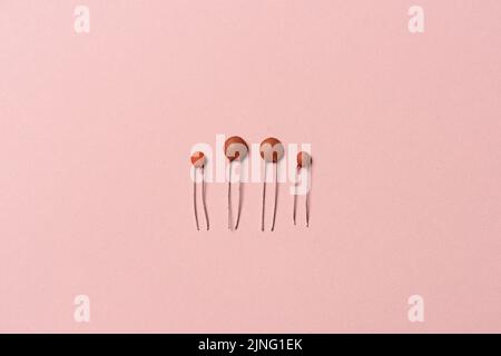capacitor isolated on a pink background Stock Photo - Alamy