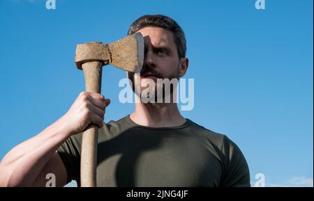 confident man with axe. caucasian man cover face with ax. brutal man on ...