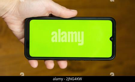 mobile phone with green chroma key on touch screen in woman hands Stock ...