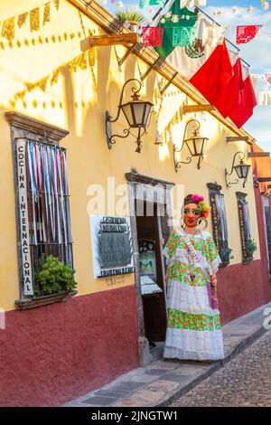 A mojiganga, or giant puppet made from papier mâché walks through the ...