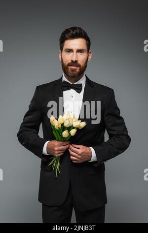tux fashion. handsome bearded man in tux isolated on grey background ...