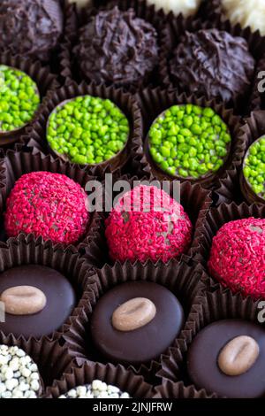 Packed chocolate. Assortment of packed truffle chocolates on a white ...