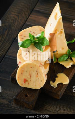 Stack of cheese with tomatoes and seasoning and Swiss cheese on with ...