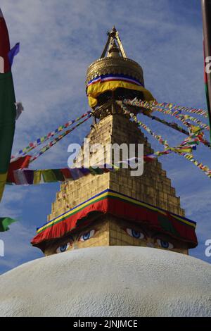 A vertical low angle shot of colorful balloons floating in the air with ...