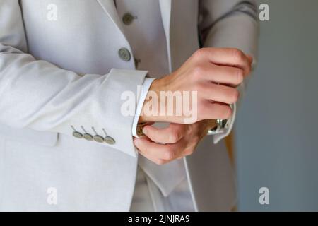 Bridegroom adjusting cuff Stock Photo - Alamy