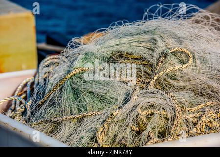 A closeup shot of a pile of fishing nets near the water Stock Photo - Alamy
