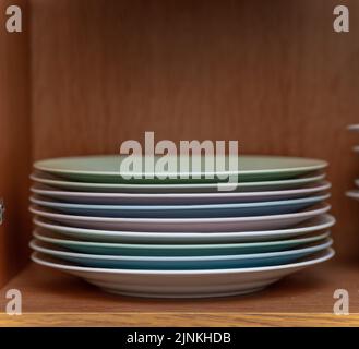 Stack of nine plates in multiple colors Stock Photo - Alamy