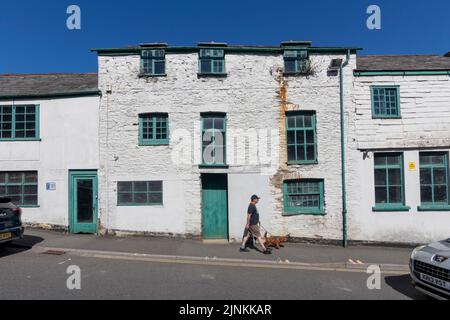 A colourful (lots of character) run down building. Broken windows ...