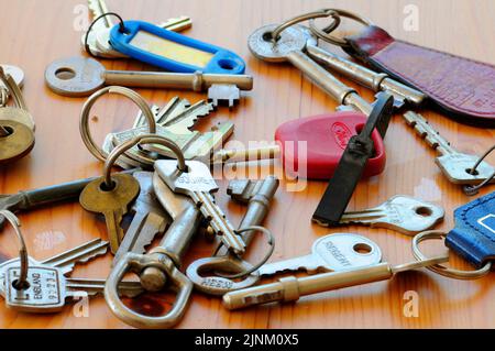 Assortment of various keys and fobs on table Stock Photo - Alamy