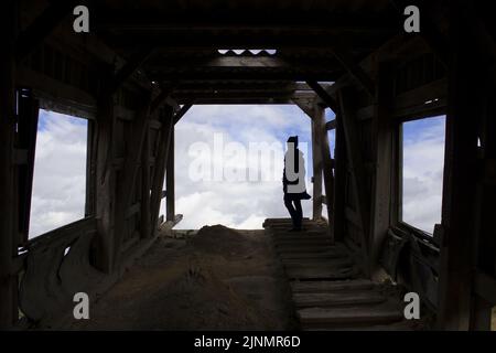 stairs leading to heaven. ruined industrial building on stilts with a ...