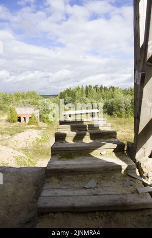 stairs leading to heaven. ruined industrial building on stilts with a ...