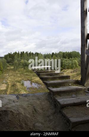 stairs leading to heaven. ruined industrial building on stilts with a ...