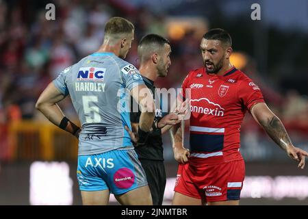 Referee Jack Smith speaks to Ash Handley #5 of Leeds Rhinos and Elliot ...