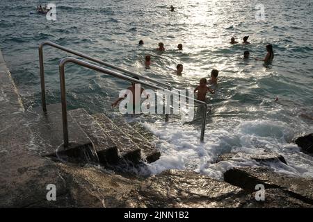 Kids playing with the waves in Piran on the slovenian coast Stock Photo ...