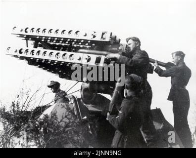 German Soldiers Waffen SS load a wounded comrade onto an Armoured ...