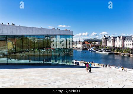 Pedestrians on the white forecourt and roof of the opera house in ...