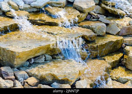 Beautiful cool and refreshing running stream along the stones and rocks ...
