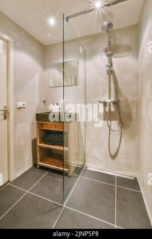 Sinks with mirrors and shower box with glass door in modern bathroom ...