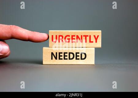 Urgently needed symbol. Concept words Urgently needed on wooden blocks ...